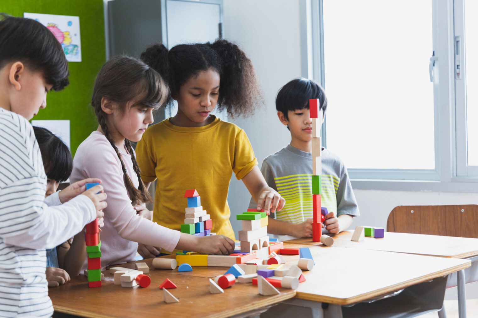 group of Diversity of school students playing wooden blocks in ...